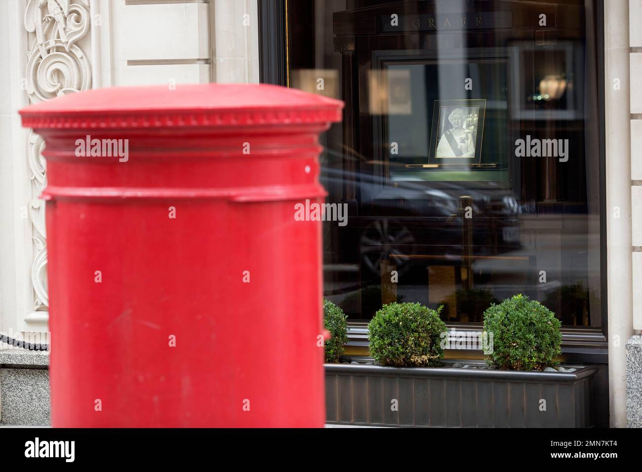 A portrait of Queen Elizabeth II is displayed in a shop window in ...