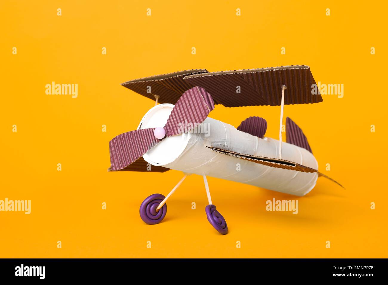 Toy plane made of toilet paper hub on yellow background Stock Photo - Alamy