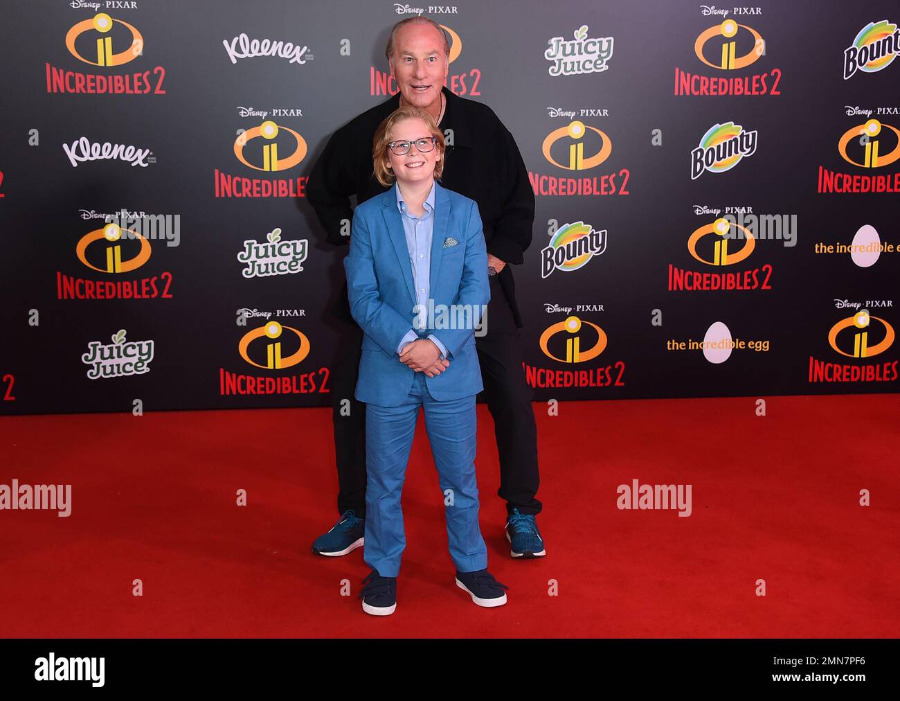 Craig T. Nelson, in background, and Huck Milner arrive at the world ...