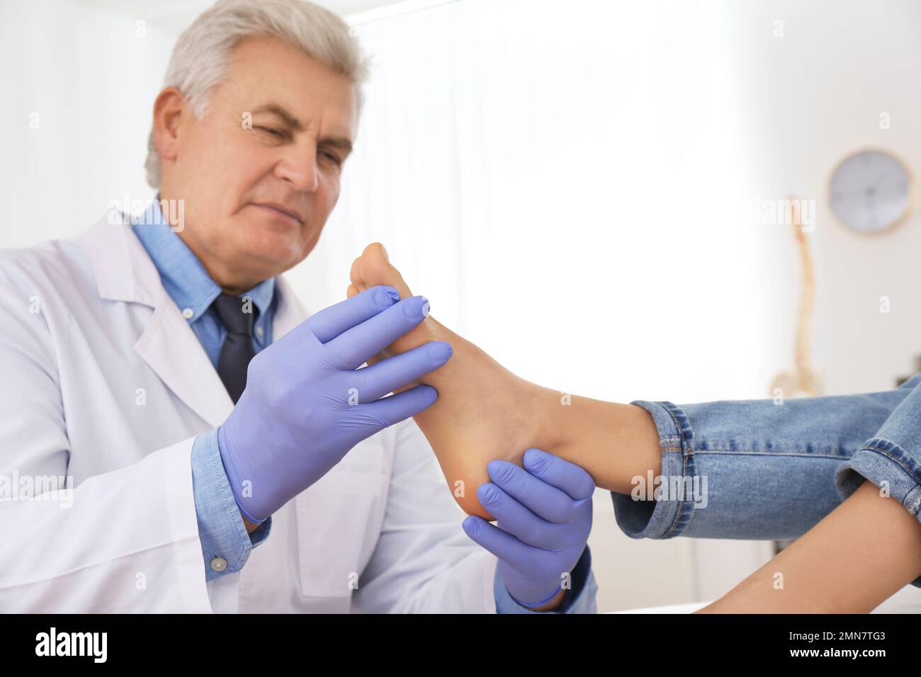 Doctor checking patients leg in hi-res stock photography and images - Alamy