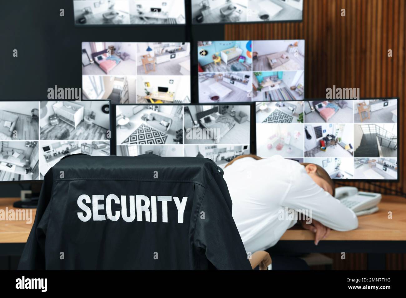 Tired security guard sleeping at workplace in office Stock Photo - Alamy