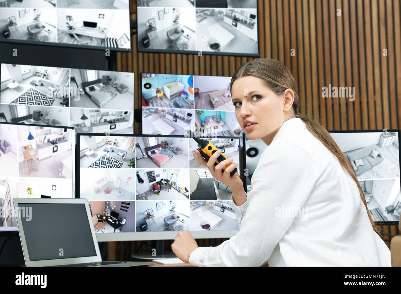 Security guard using portable transmitter at workplace Stock Photo - Alamy