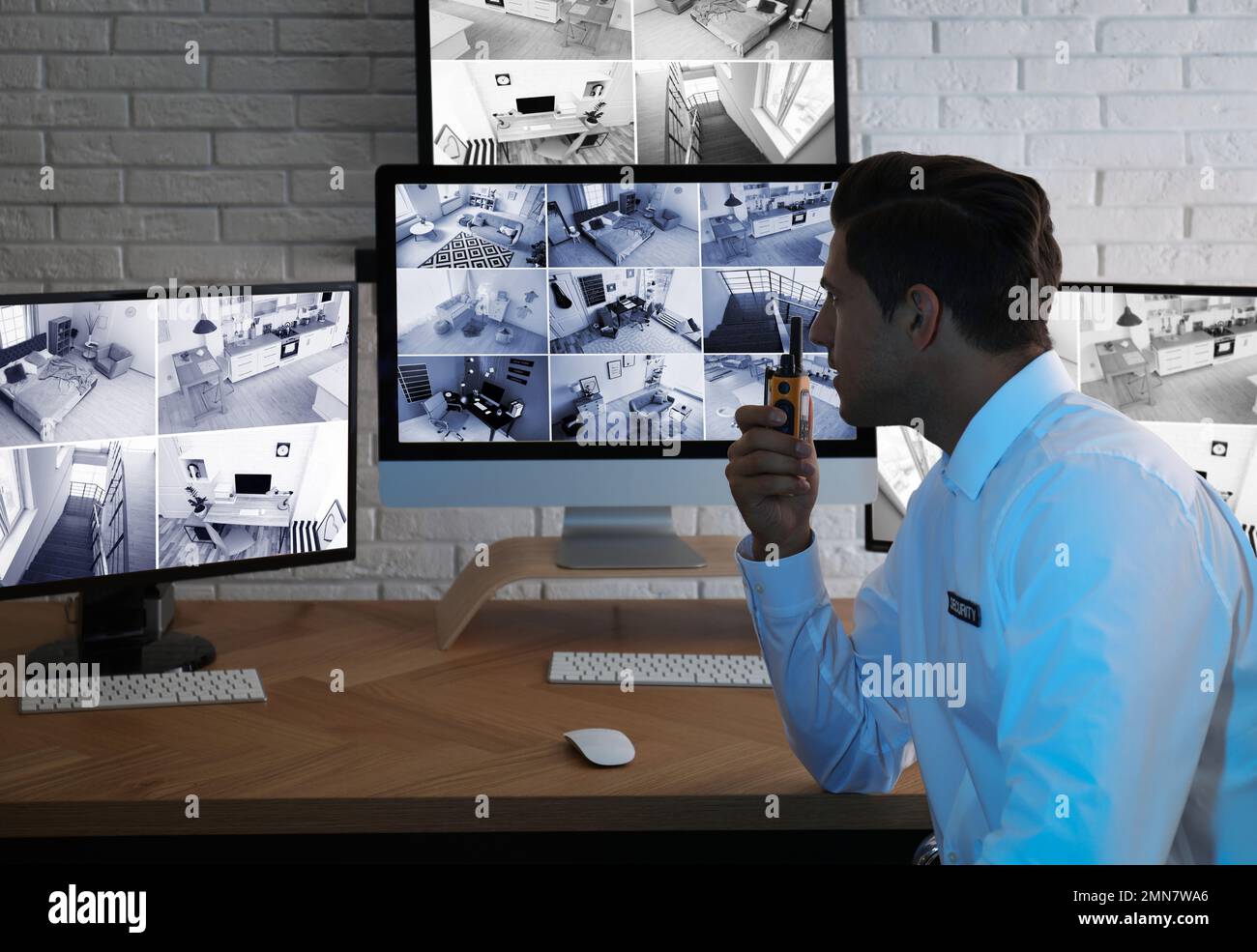 Male security guard with portable transmitter at workplace Stock Photo ...
