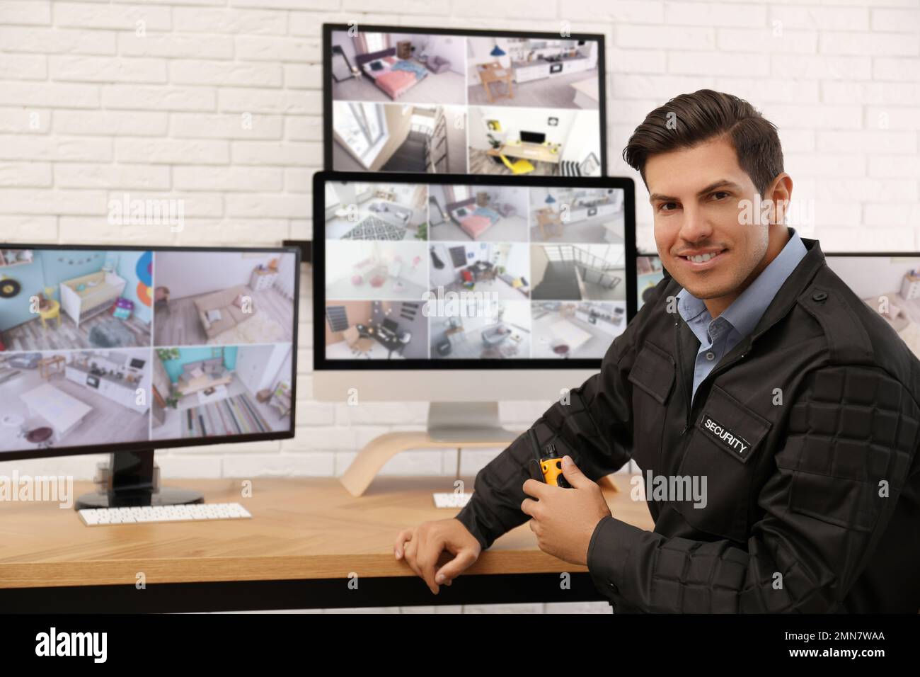 Male security guard with portable transmitter at workplace Stock Photo ...