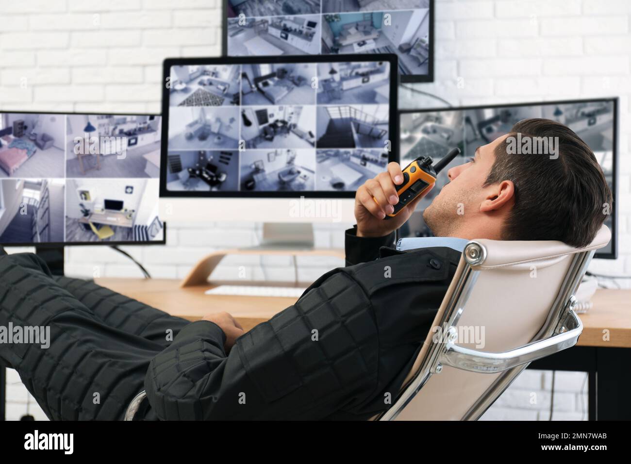 Male security guard with portable transmitter at workplace Stock Photo ...