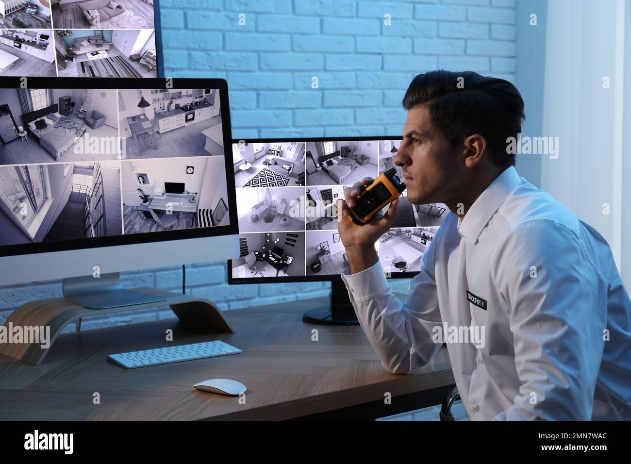 Male security guard with portable transmitter at workplace Stock Photo ...