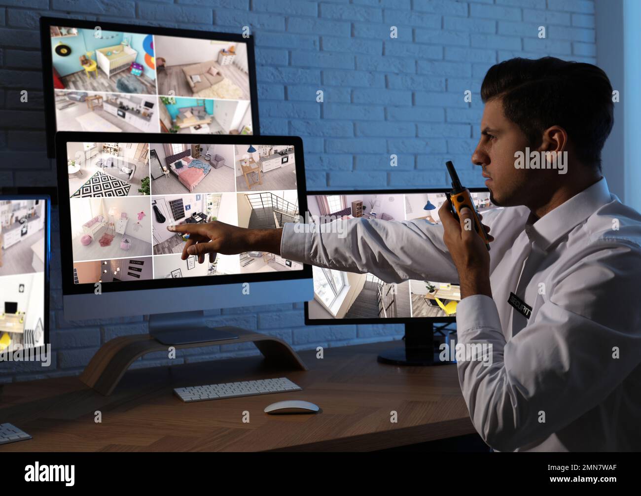 Male security guard with portable transmitter at workplace Stock Photo ...