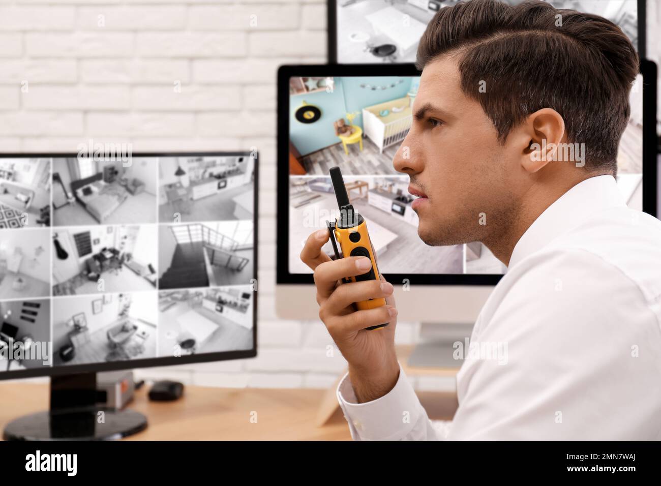 Male security guard with portable transmitter at workplace Stock Photo ...
