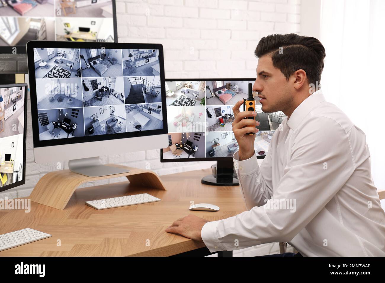 Male security guard with portable transmitter at workplace Stock Photo ...
