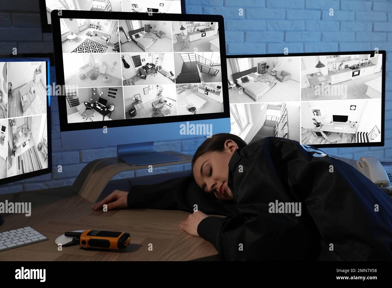 Female security guard sleeping near monitors at workplace Stock Photo ...