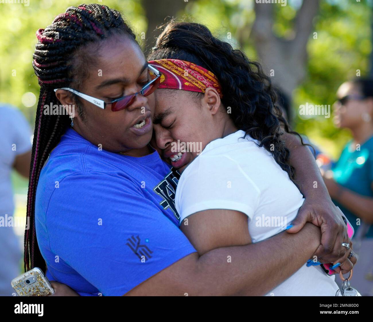 Community activist and family friend Barbara Robinson, left, comforts ...