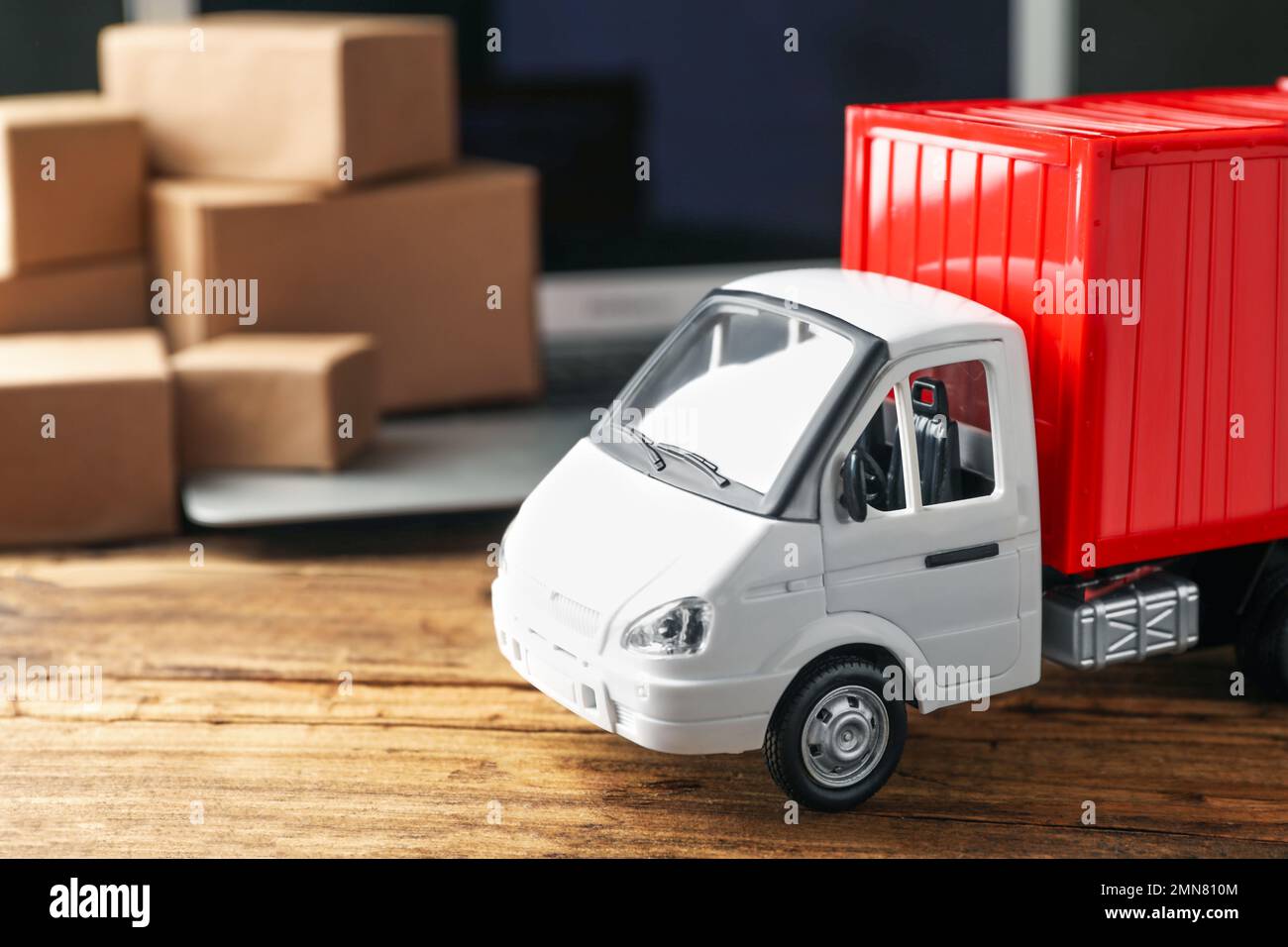 Toy truck on wooden table. Logistics and wholesale concept Stock Photo ...