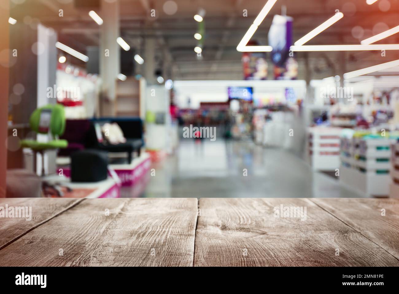 Empty wooden surface and blurred view of furniture store in mall. Space ...