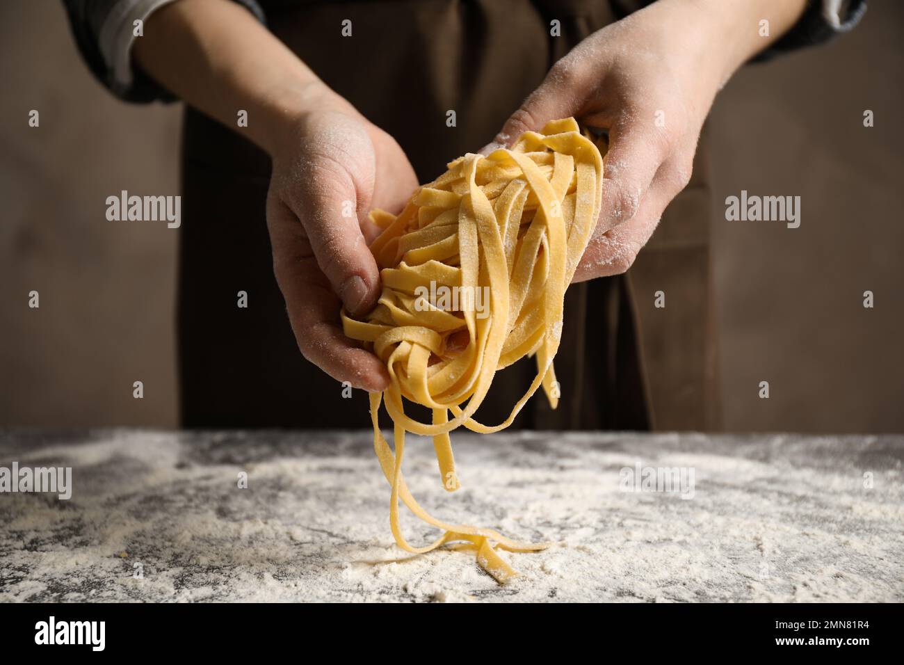 Woman holding raw spaghetti hi-res stock photography and images - Alamy