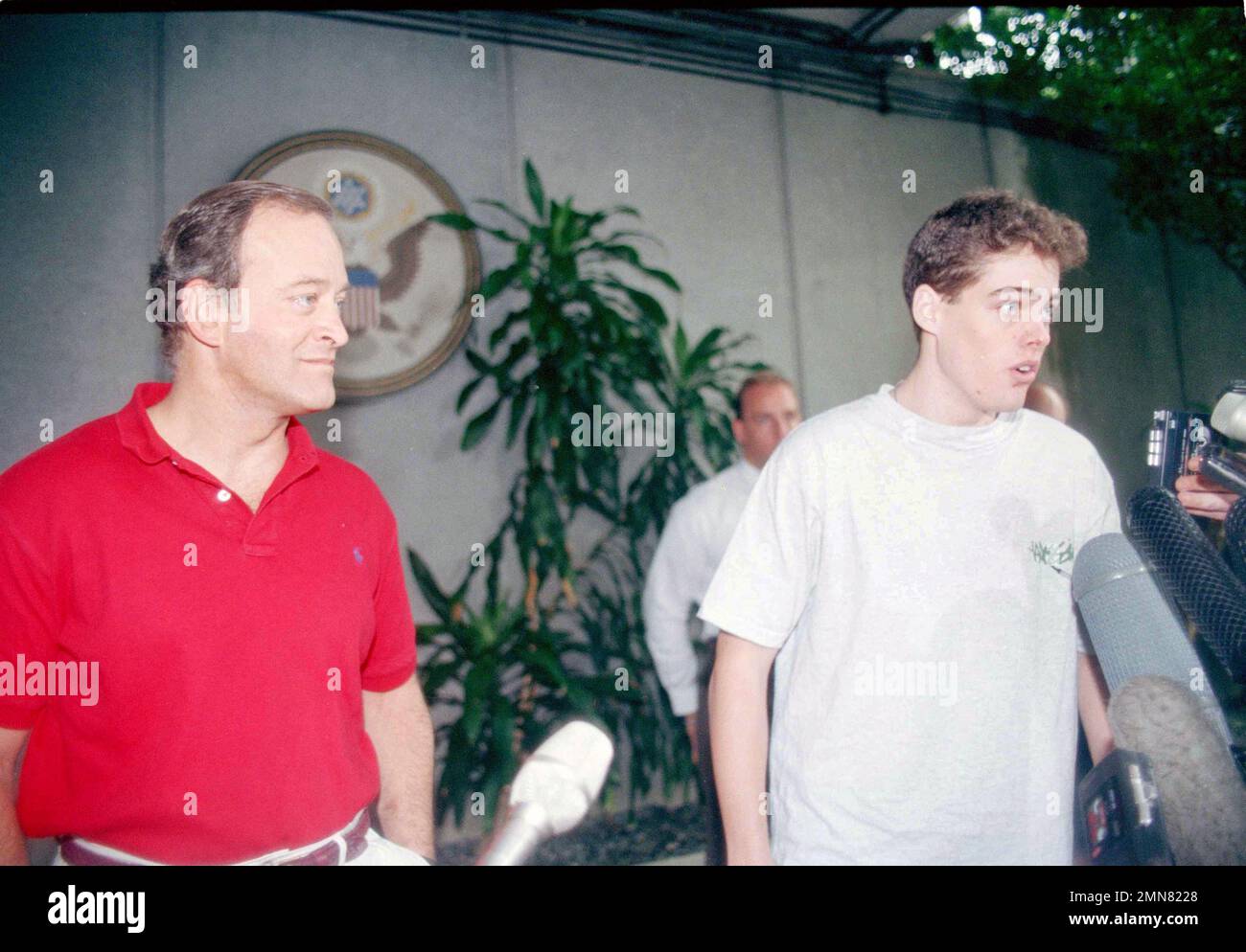 Michael Fay, right, talks to reporters inside the U.S. Embassy in ...