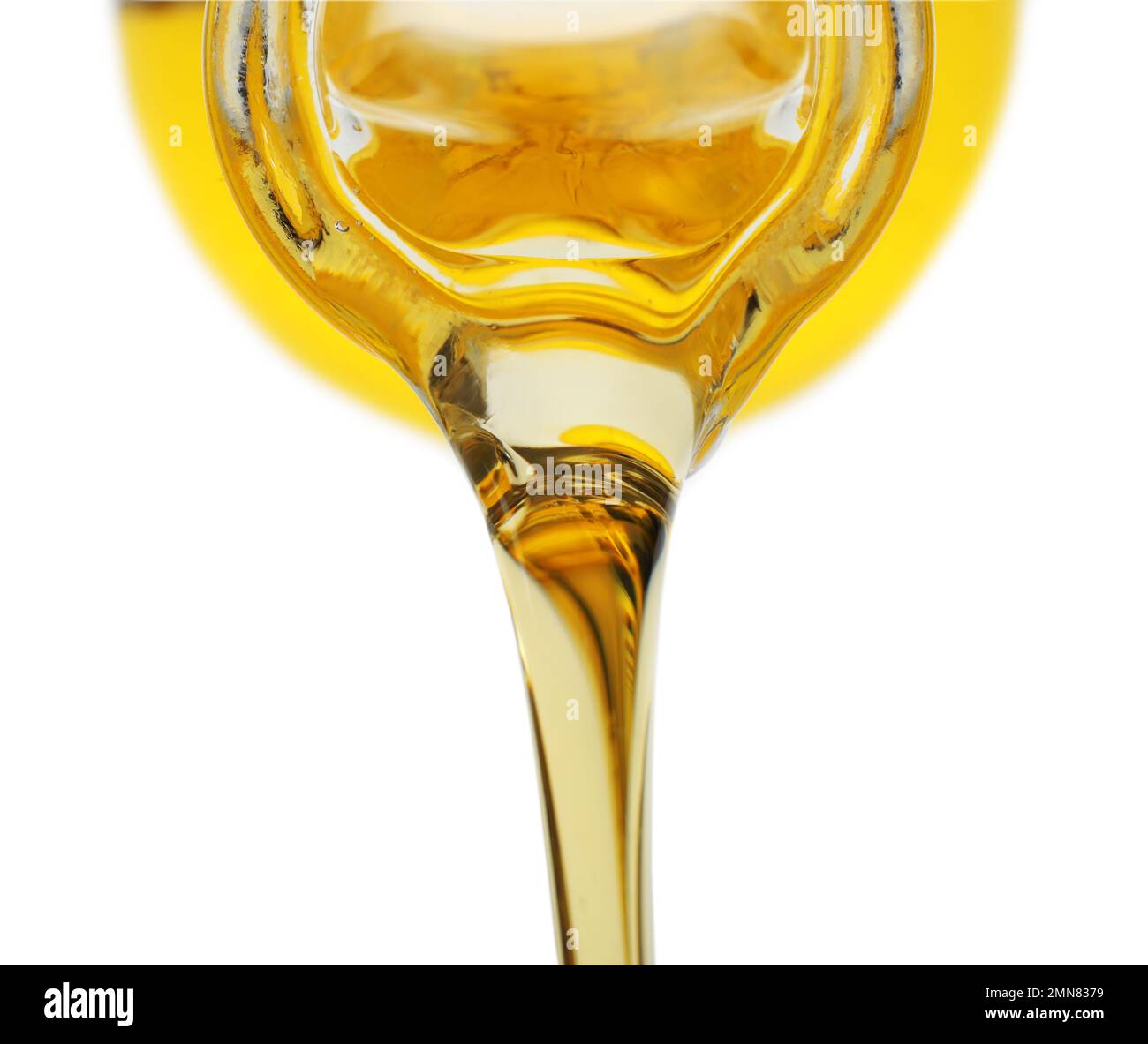 Pouring cooking oil from pitcher isolated on white Stock Photo - Alamy