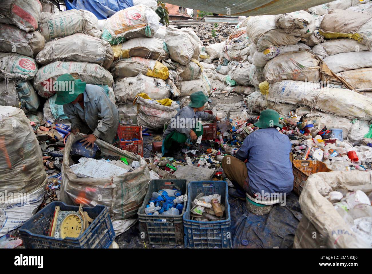 Nepalese workers segregate plastic waste for recycling at a junkyard in ...