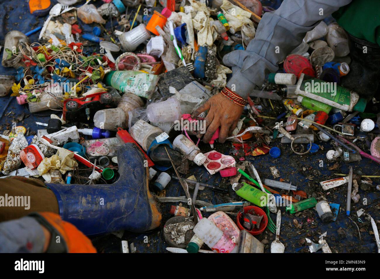 Nepalese workers segregate plastic waste for recycling at a junkyard in ...