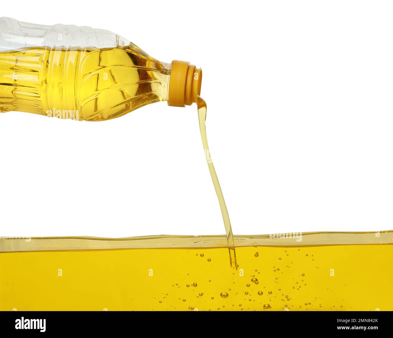 Pouring cooking oil from bottle on white background Stock Photo - Alamy
