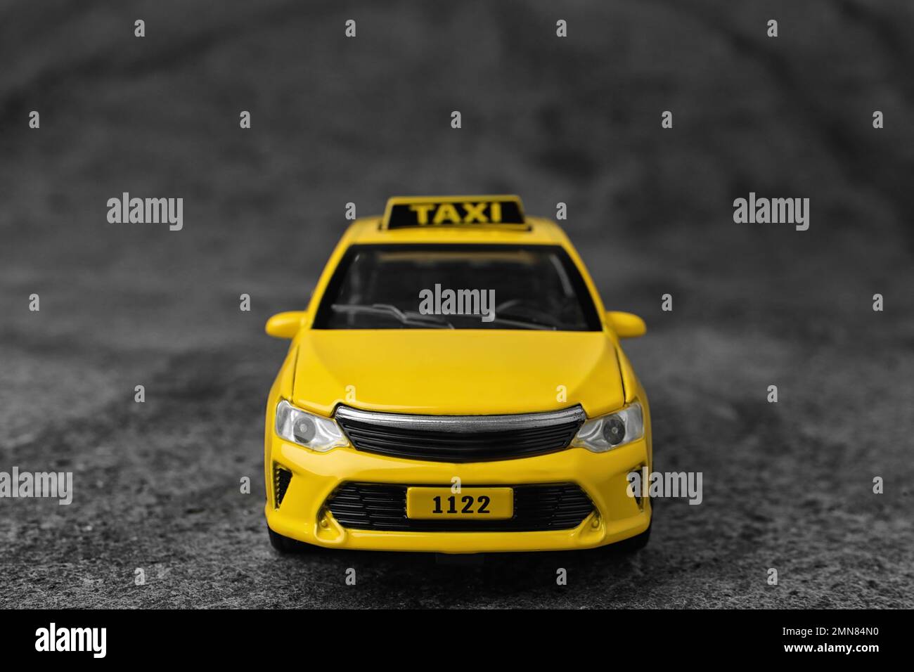 Yellow taxi car model on grey background Stock Photo - Alamy