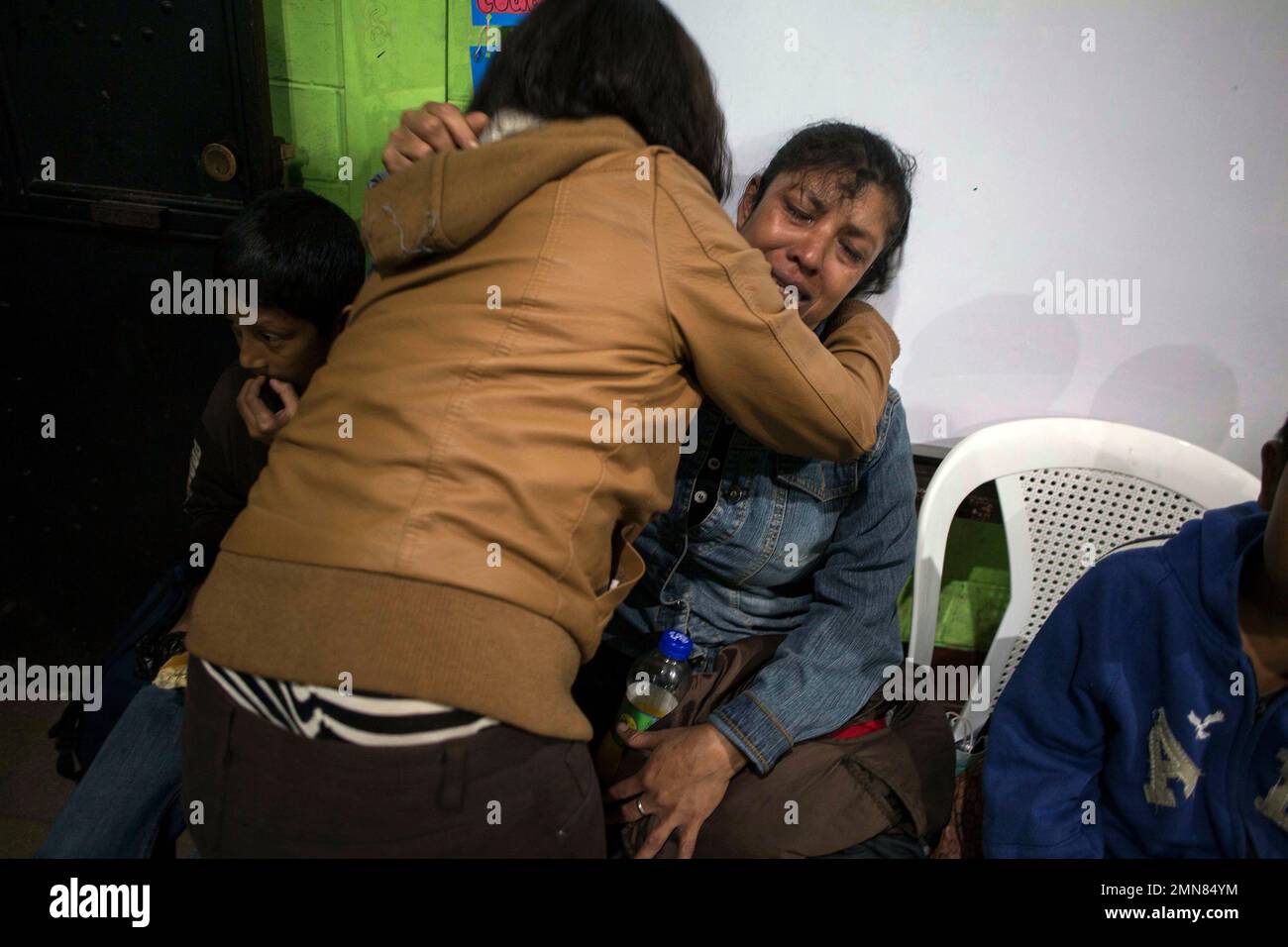 Ruth Rivas, who says she has two missing children, is consoled by a ...