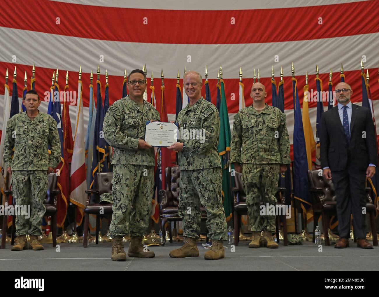 Adm. Daryl Caudle, commander, U.S. Fleet Forces command, presents Rear ...