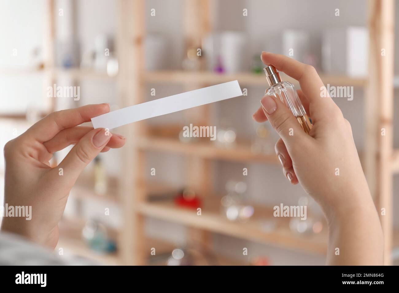 Woman spray perfume tester hi-res stock photography and images - Alamy