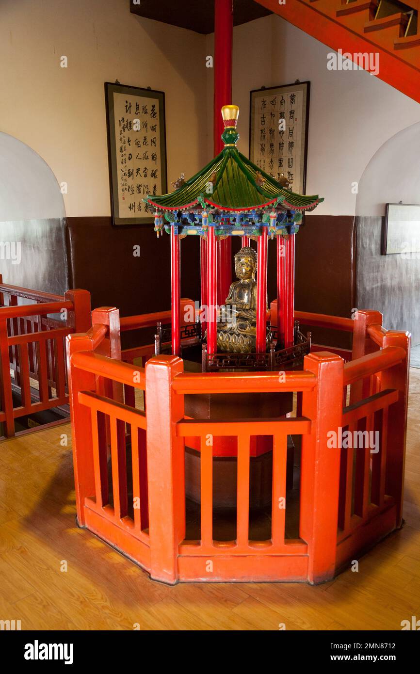 Small Buddhist shrine on an intermediate level, or landing, inside the ...