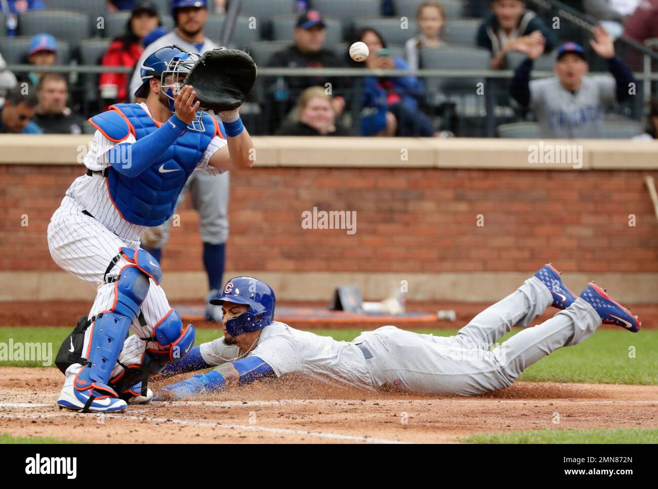Chicago Cubs' Javier Baez, right, slides past New York Mets catcher ...