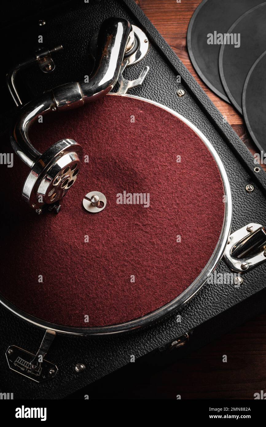 Retro portable turntable with vynil on wood table Stock Photo - Alamy