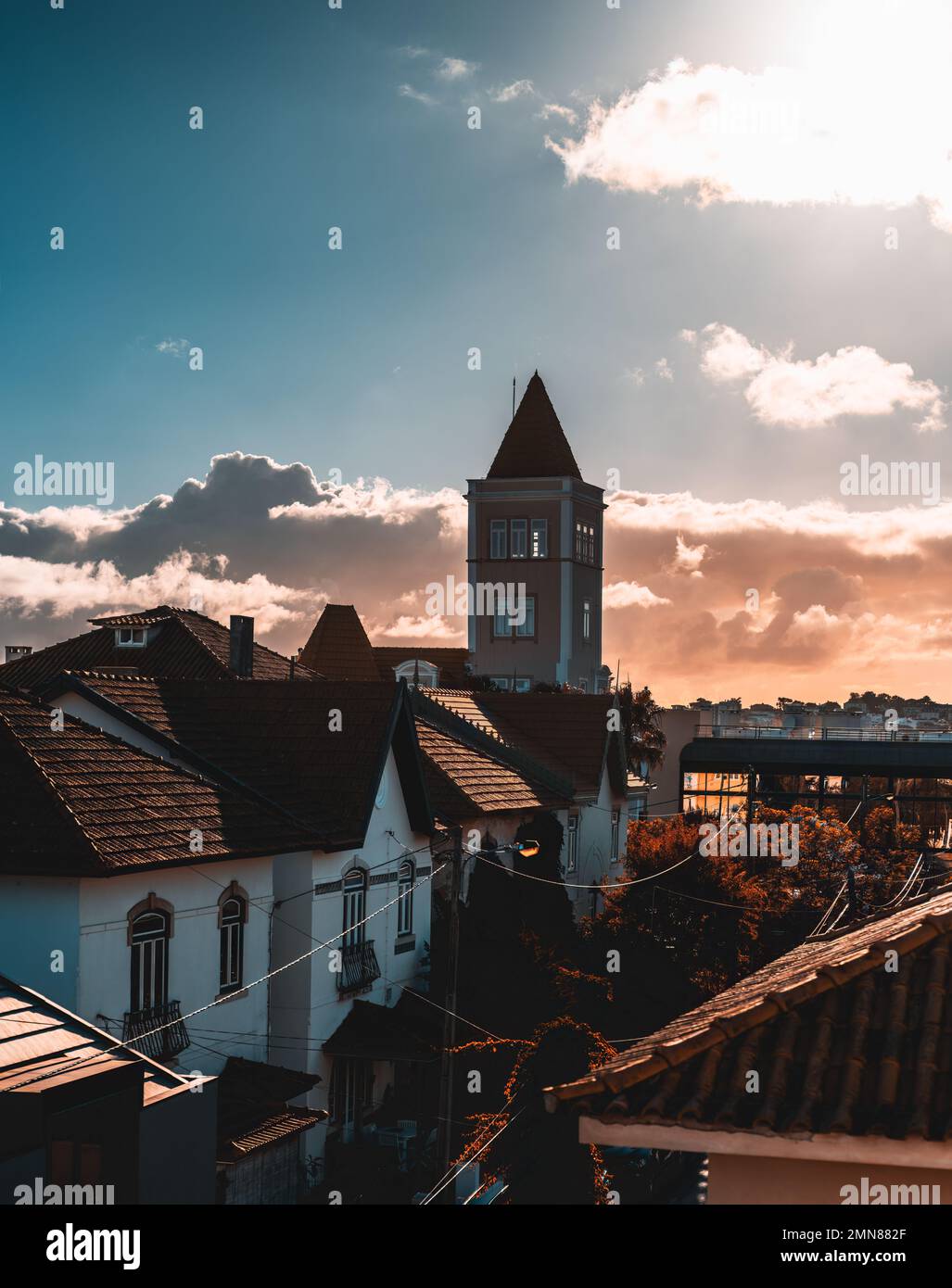 A vertical backlit suburban landscape with a city street and a triangle ...
