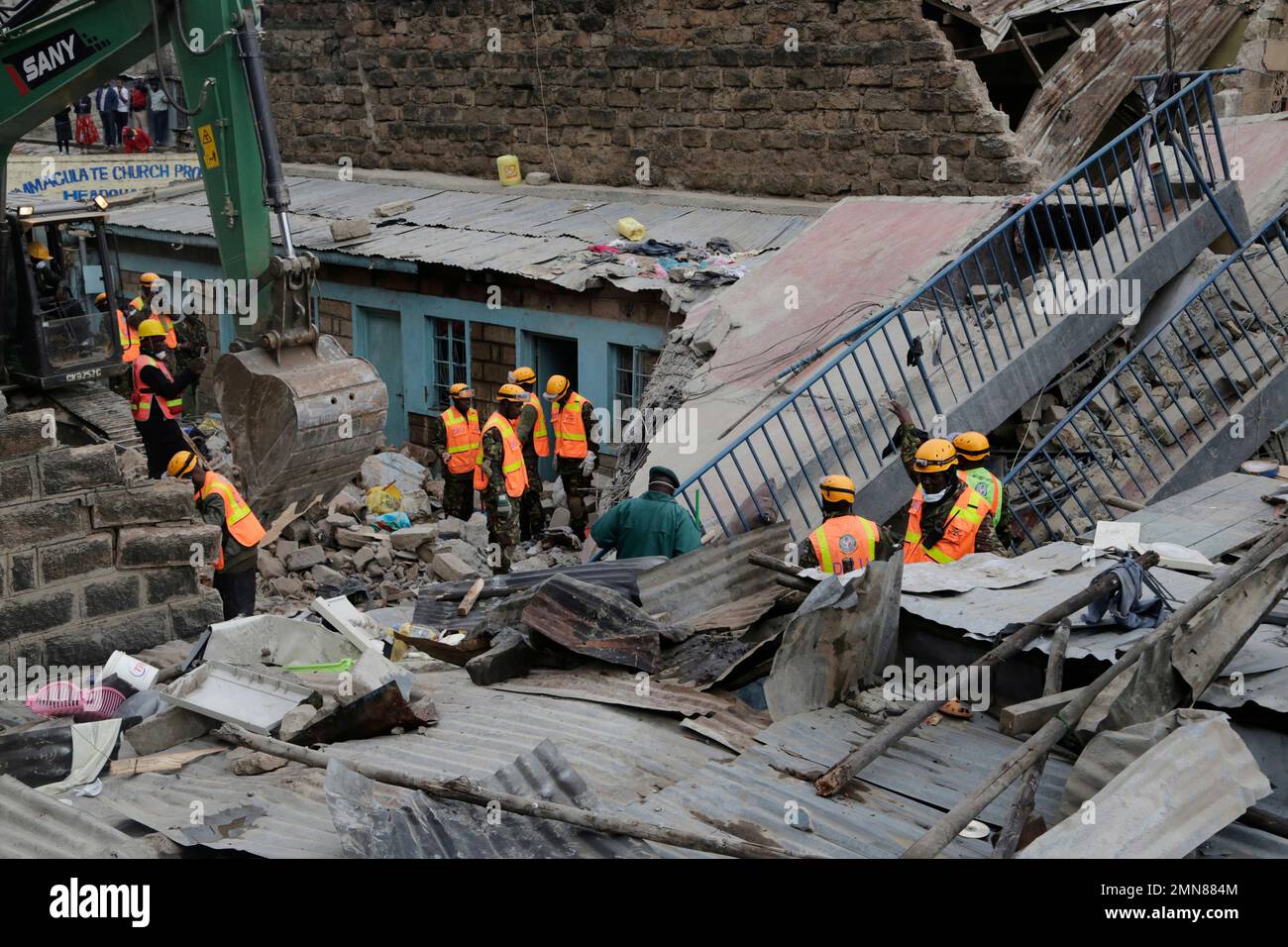 Rescuers work at the site of a five-storey collapsed building in the ...