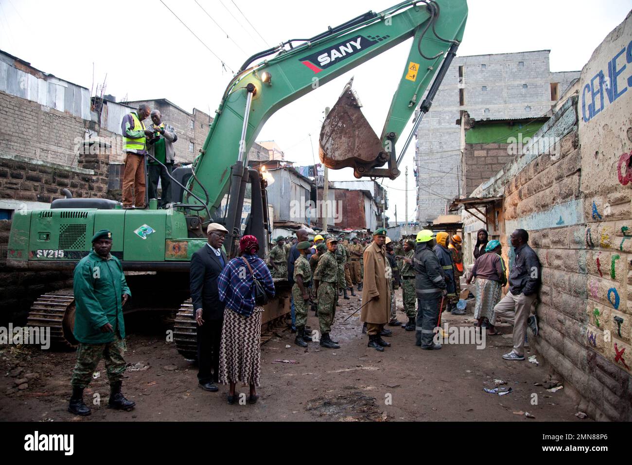 Rescue workers gather at the scene of a collapsed building in Huruma ...