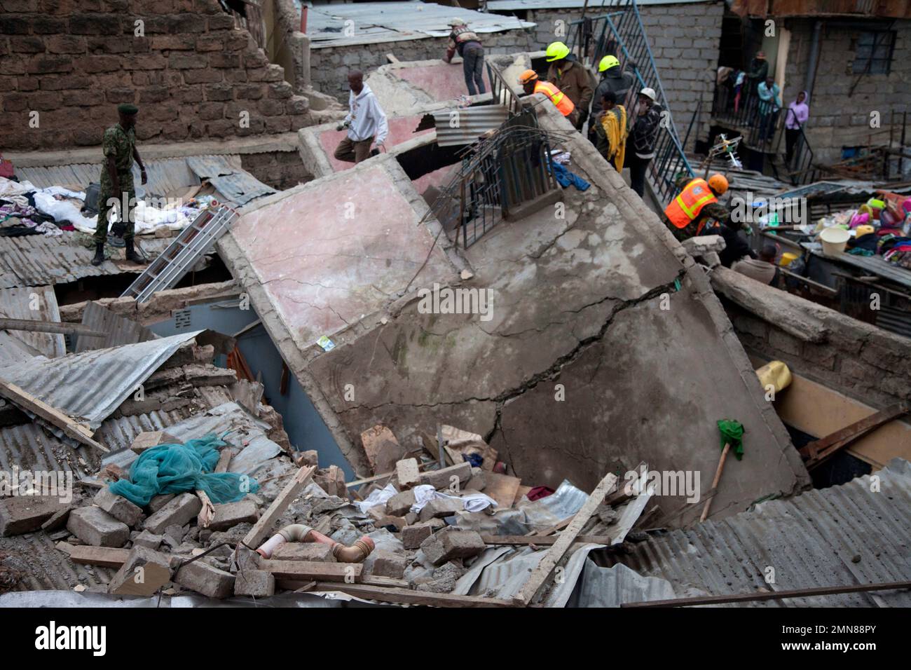 Rescue workers at the scene of the collapsed building in Huruma estate ...