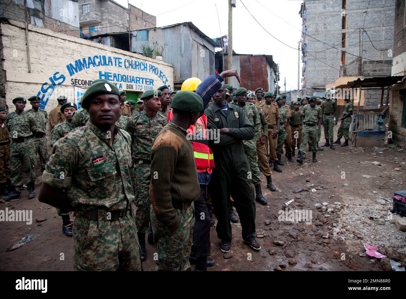 Rescue workers from National Youth Service gather at the scene of the ...
