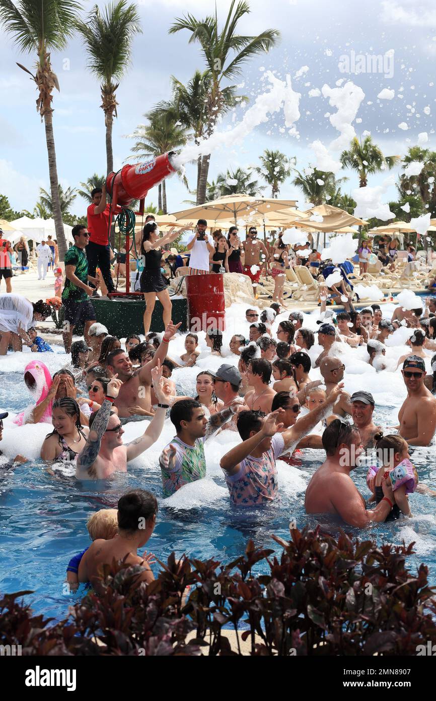 Guests having fun at a New Year's Eve foam party in a swimming pool in ...