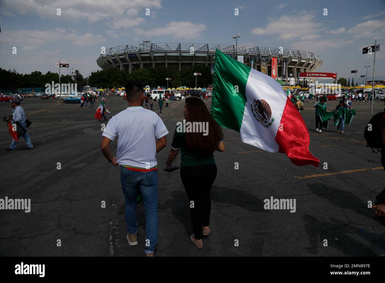 A fan arrives with a Mexican national flag to the Azteca Stadium for a ...
