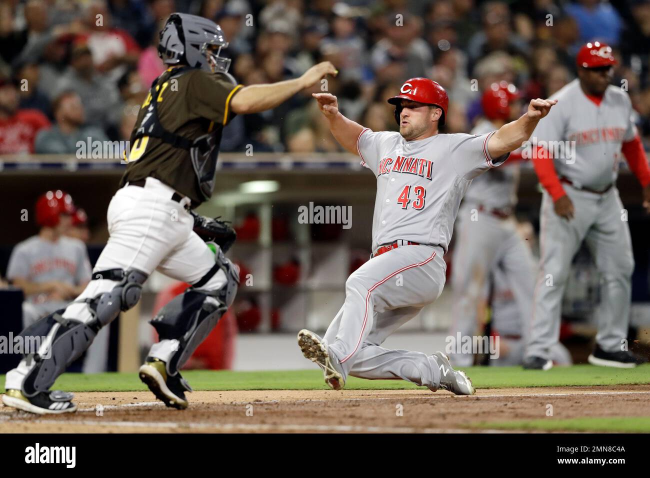 The Cincinnati Reds' Scott Schebler (43) scores off a two-RBI double by ...