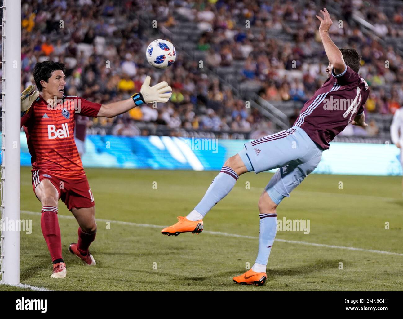 Vancouver Whitecaps goalkeeper Brian Rowe defends shot by Colorado ...