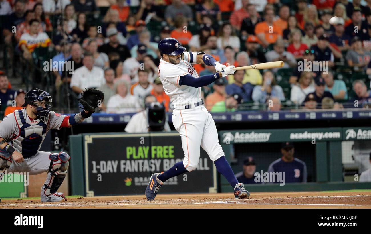 Houston Astros' Carlos Correa hits a two-run home run in front of ...
