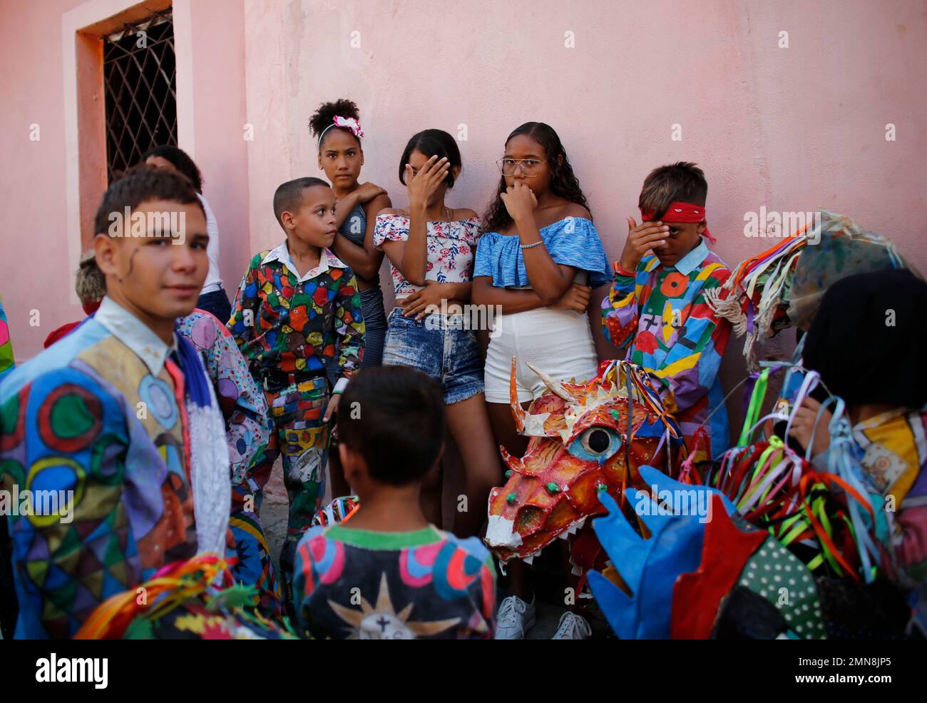Youngsters dressed as dancing devils stand together during a ...