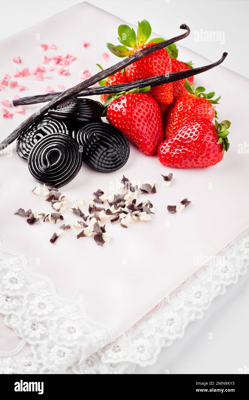 strawberries, liquorice, vanilla pods and flake chocolate Stock Photo ...