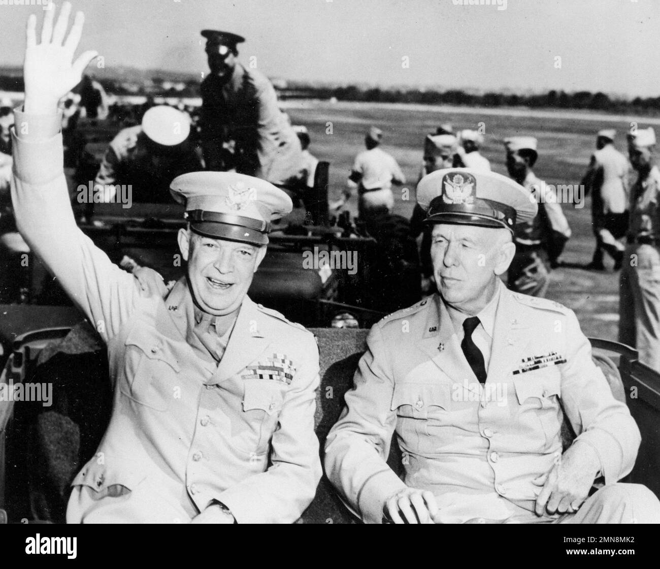 Gen. Dwight D. Eisenhower, left, waves a greeting as he leaves National ...