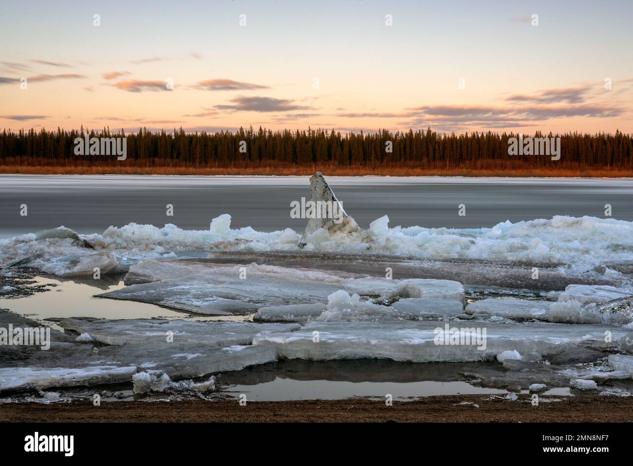 Ice drift. An ice floe in the form of a shark's fin with a reflection ...