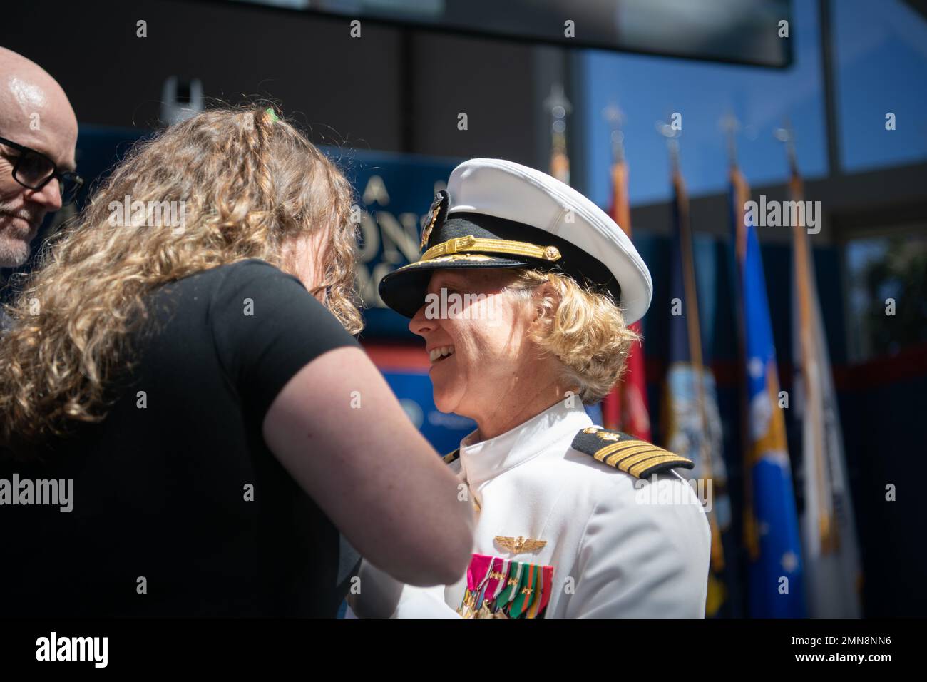 Capt. Kimberly P. Toone is pinned by her husband and daughter as she ...