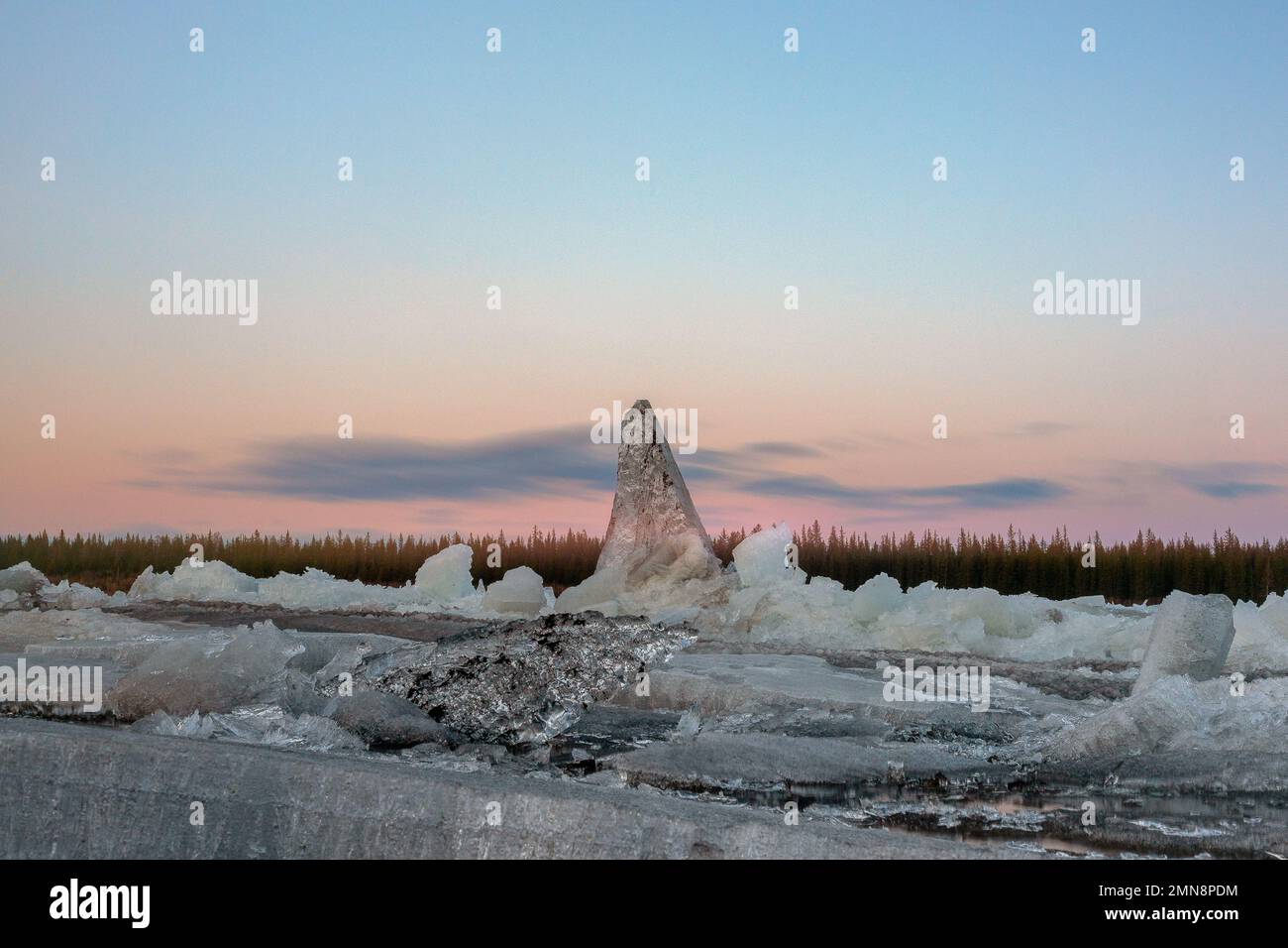 An ice floe in the form of a shark's fin sticks out of the surface of ...