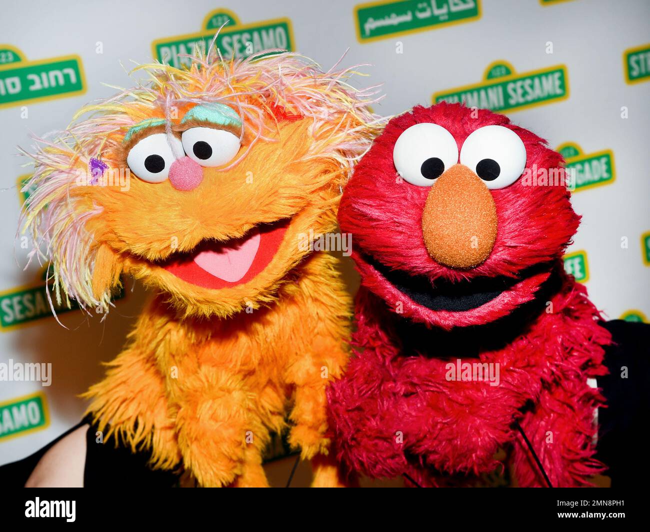 Sesame Street characters Zoe, left, and Elmo attend Sesame Workshop's ...