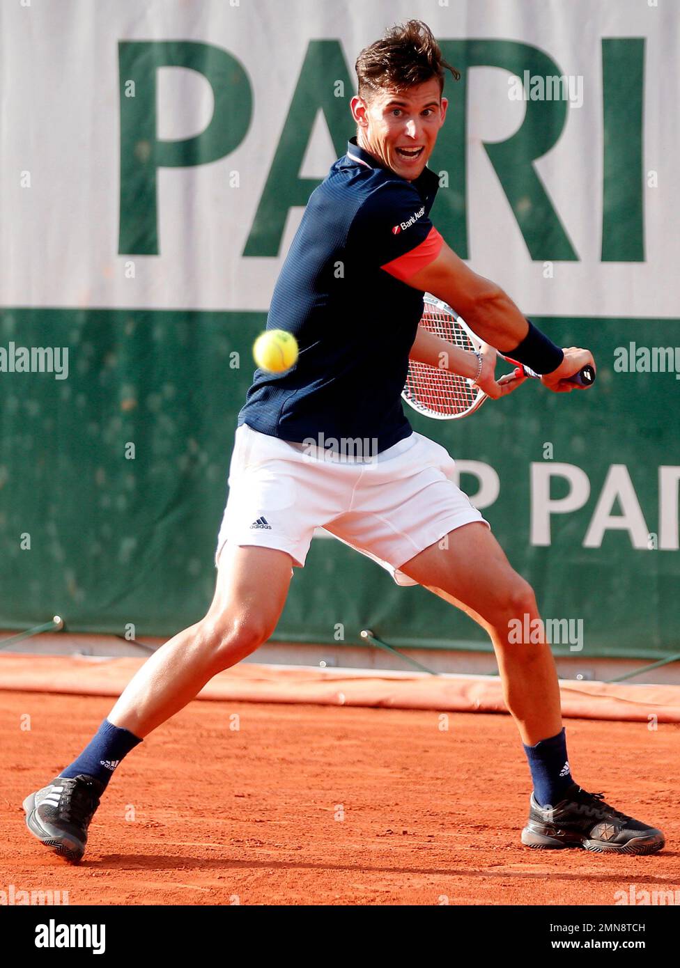 Austria's Dominic Thiem returns the ball to Greece's Stefanos Tsitsipas ...