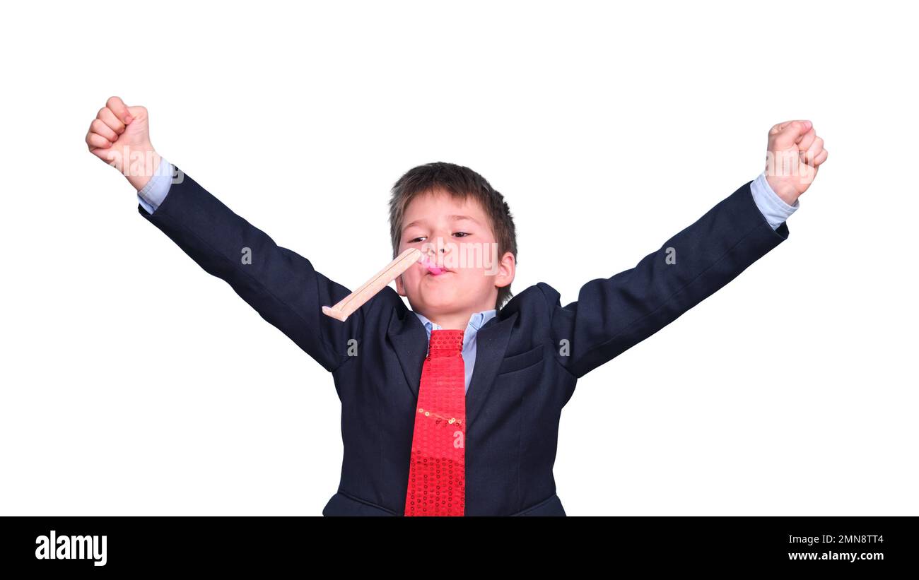 A boy in a school suit raised his hands in a victorious gesture during ...