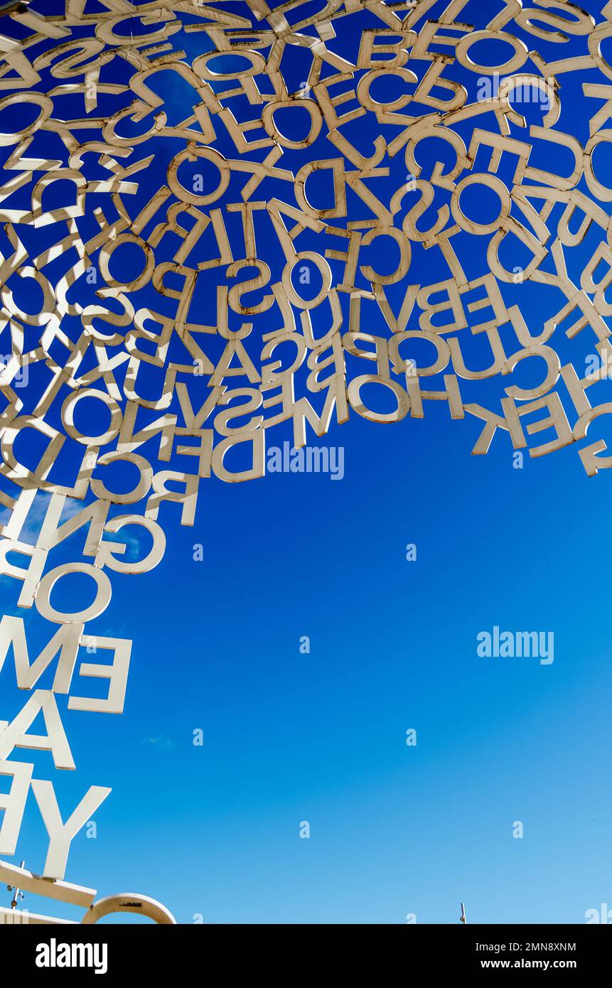 Wave of white letters in the shape of a wall with blue sky as a sea ...